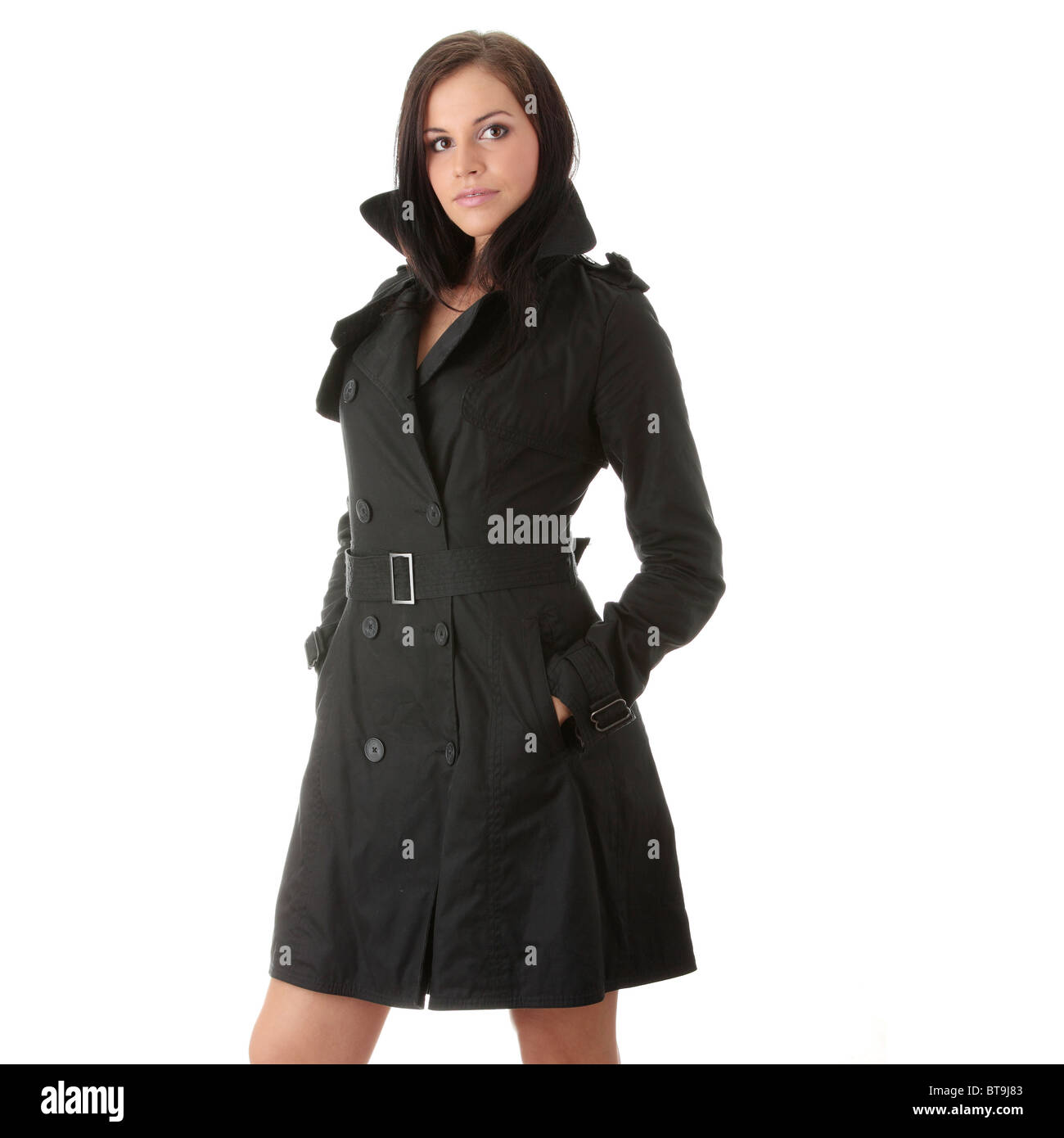 Fashion model in black coat over white background Stock Photo - Alamy