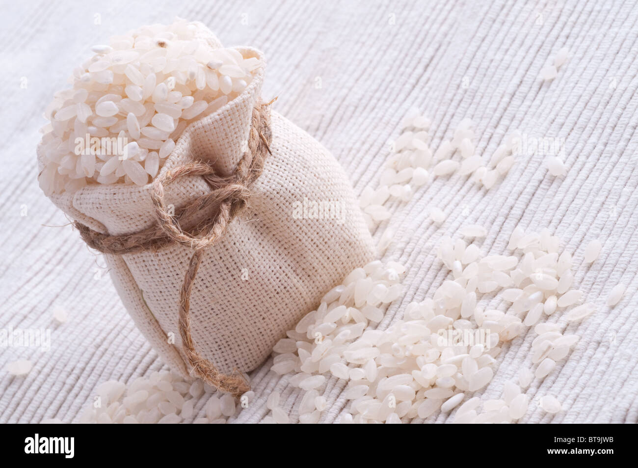 raw Rice in small sack Stock Photo - Alamy