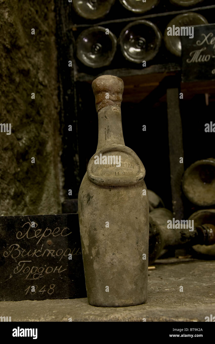 old dirty bottle with other bottles in the background Stock Photo - Alamy