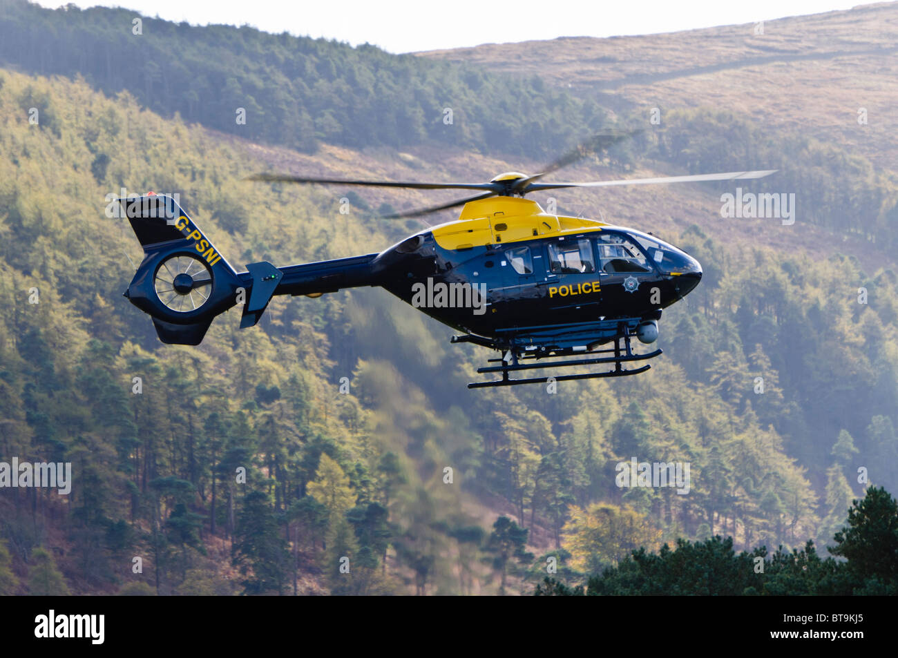 PSNI Helicopter flying through a valley in the Mourne Mountains Stock ...