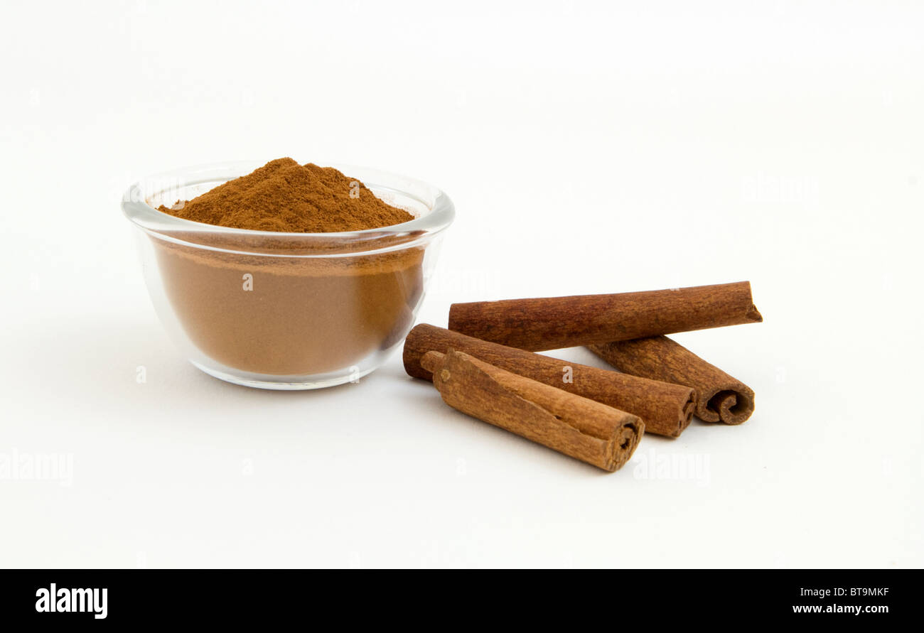 Cinnamon sticks and powder against white background Stock Photo - Alamy