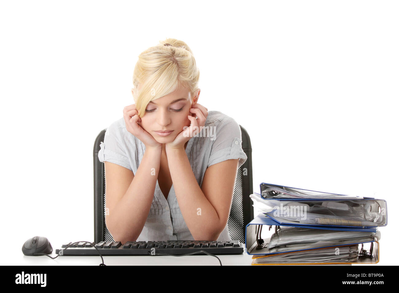 Female executive filling out tax forms while sitting at her desk ...