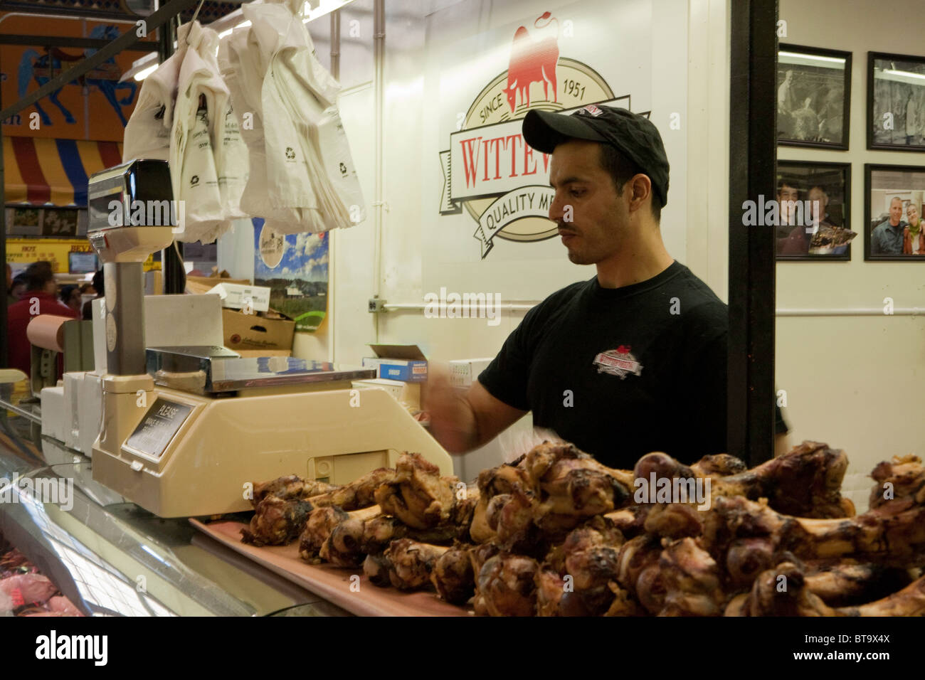A clerk in a butcher's stall st the St. Lawrence Farmer's Market weighs ...
