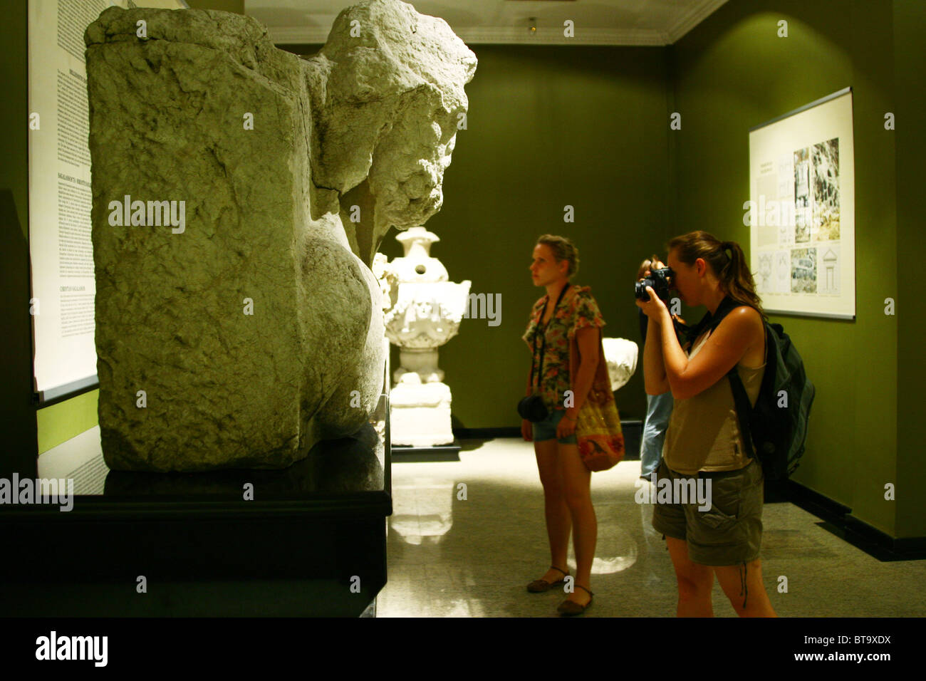 Tourists visiting the museum, girl taking picture of sculpture Stock ...