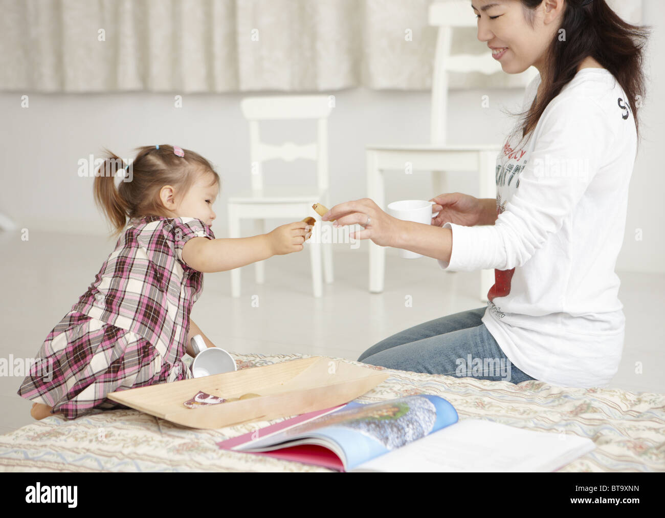 Girl giving a candy to mother Stock Photo - Alamy