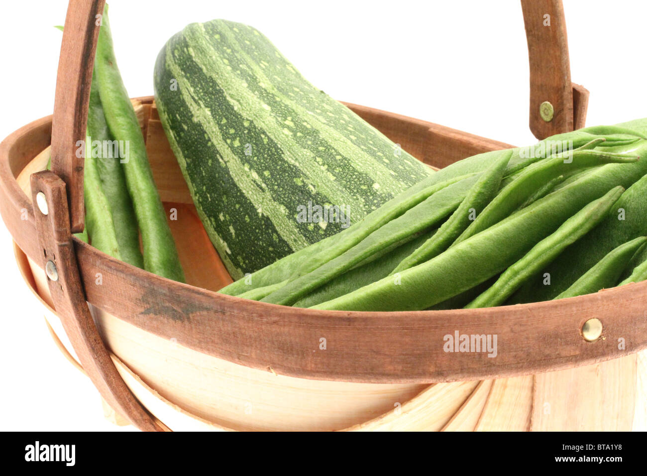Close-up on a traditional Sussex trug of fresh vegetables - white ...