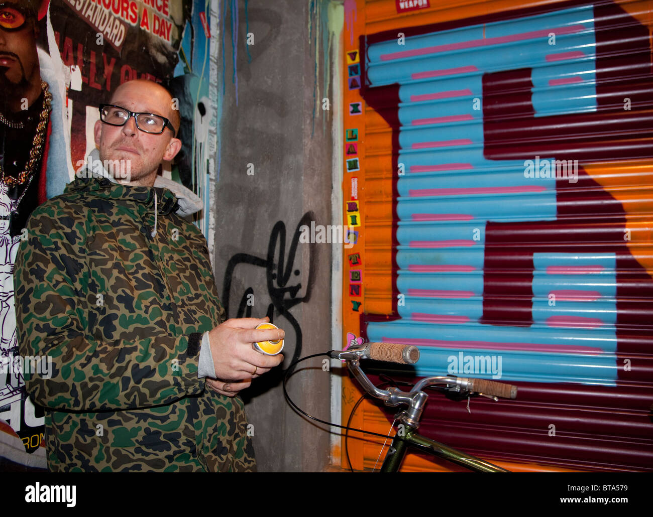 Artist Ben Eine at Moniker Art Fair, London with one of his trademark ...