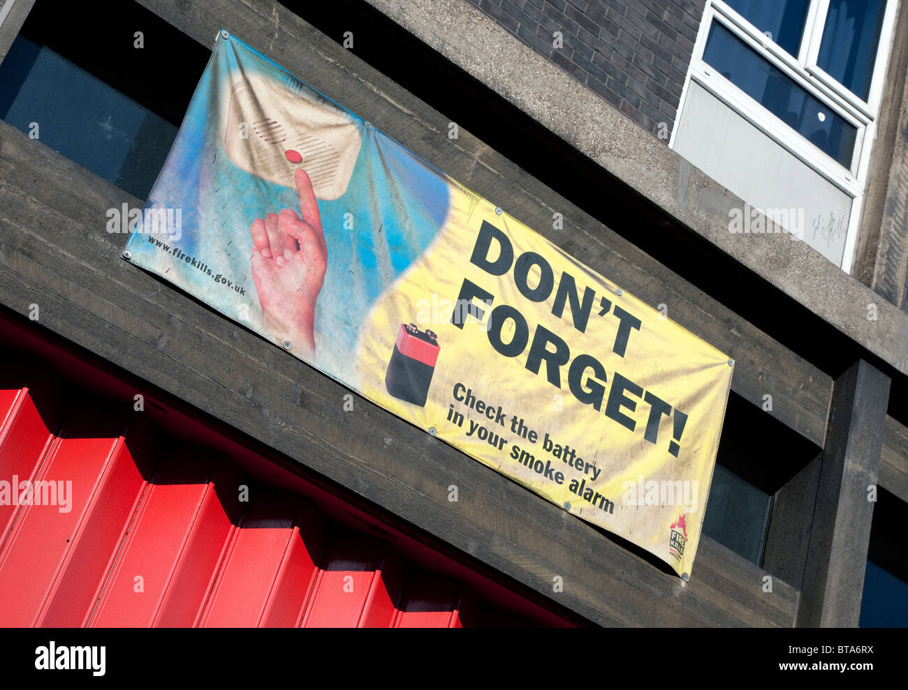 Smoke alarm battery reminder on London fire station Stock Photo - Alamy
