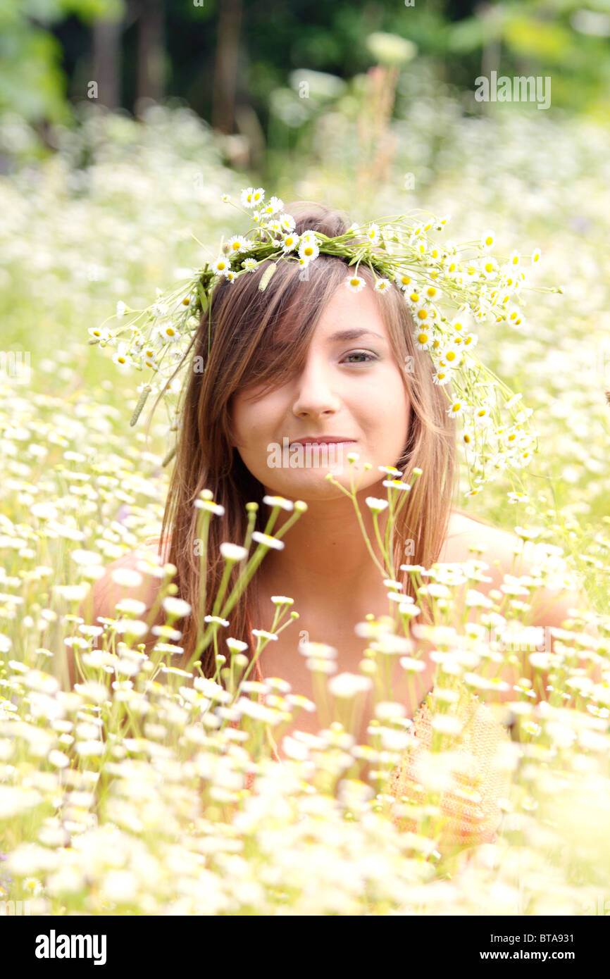 Smiling young woman on the meadow Stock Photo - Alamy