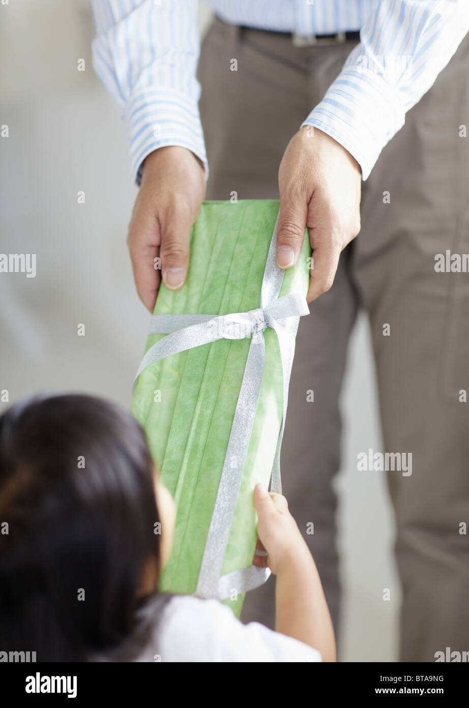 Girl giving a gift to her father Stock Photo - Alamy