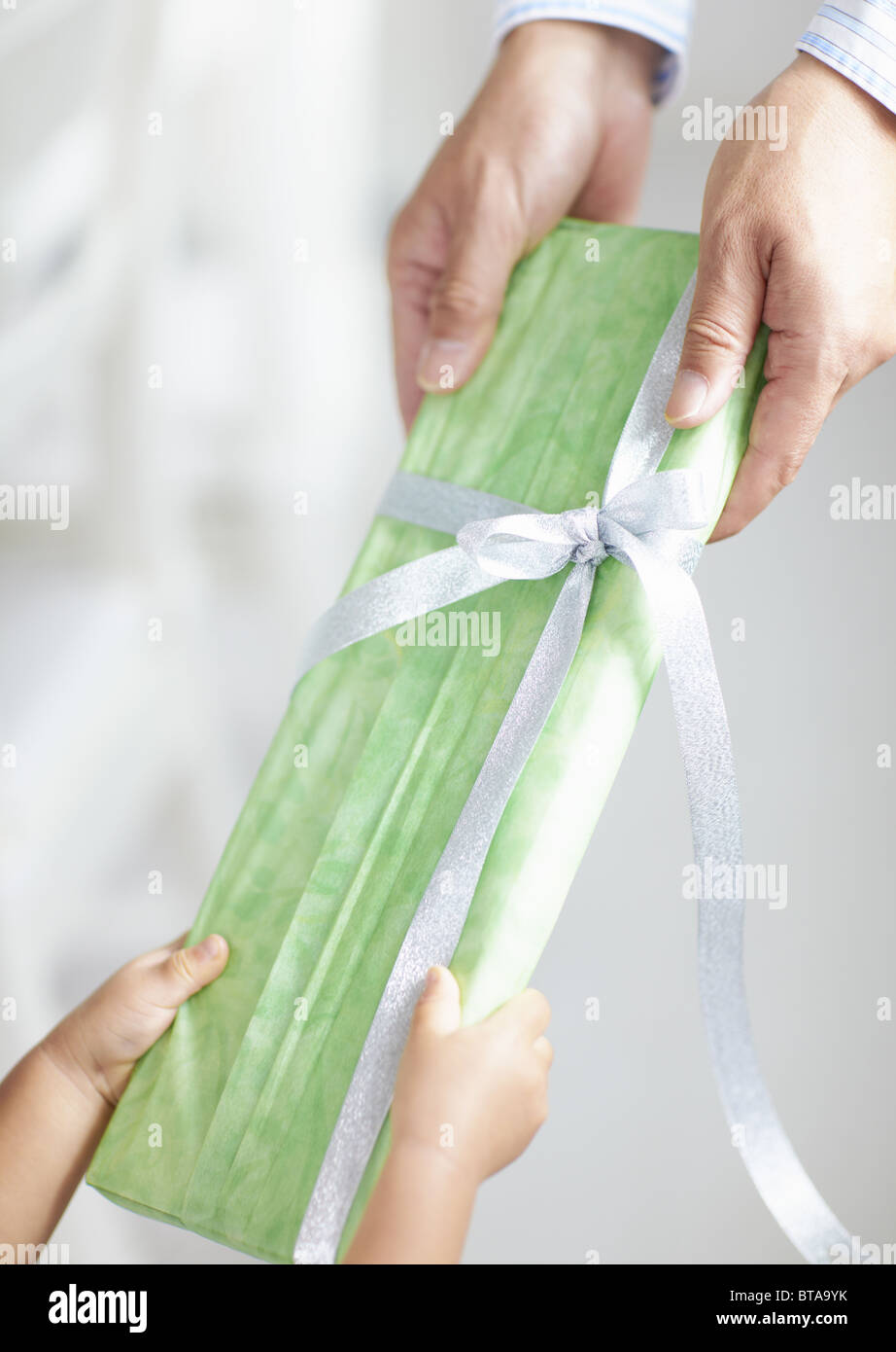 Close up of hands giving a gift Stock Photo - Alamy