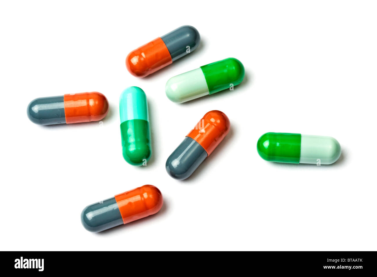 A few colorful capsules isolated on white background Stock Photo - Alamy