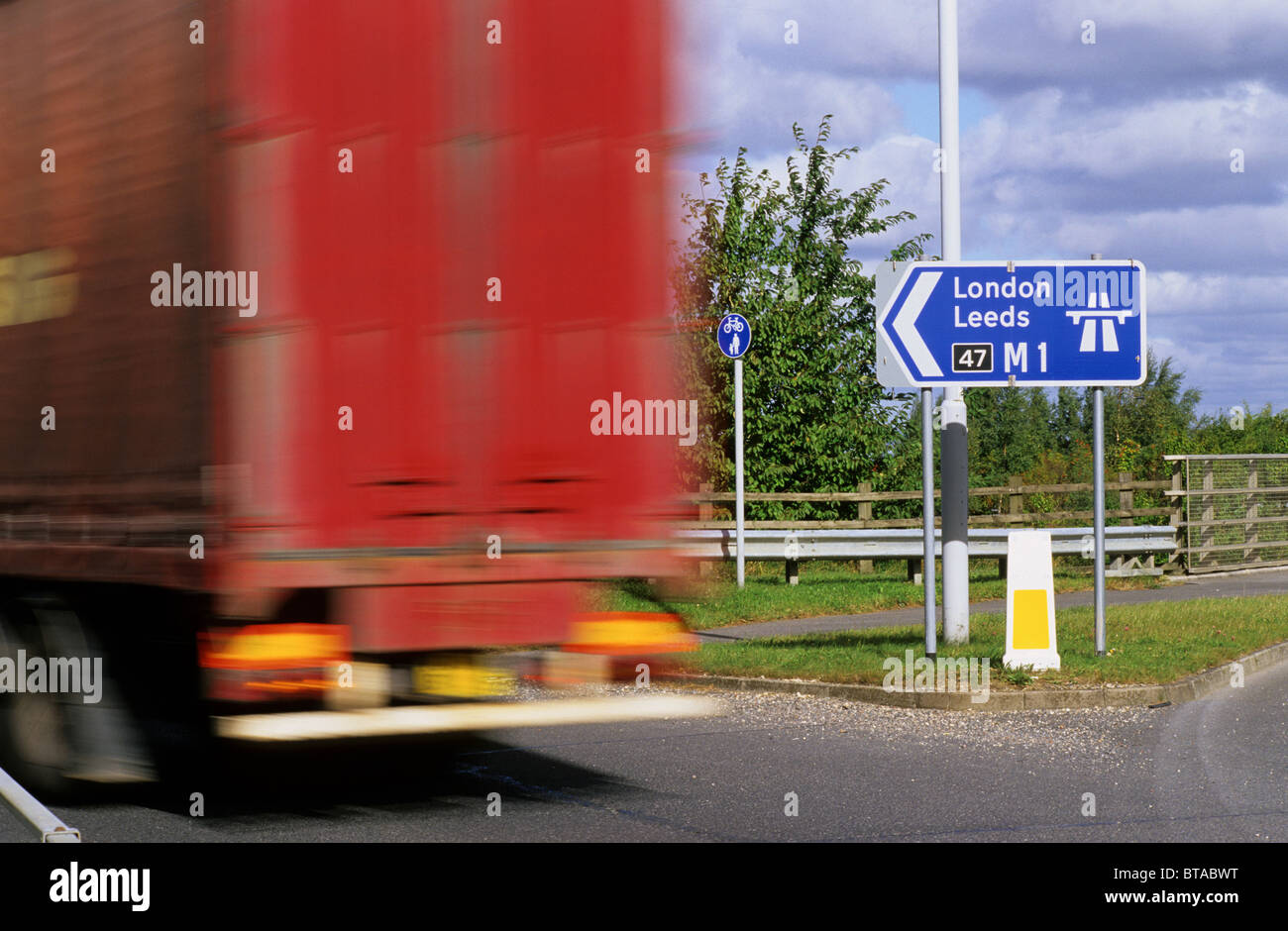 articulted lorry passing sign showing start of M1 motorway near Leeds ...