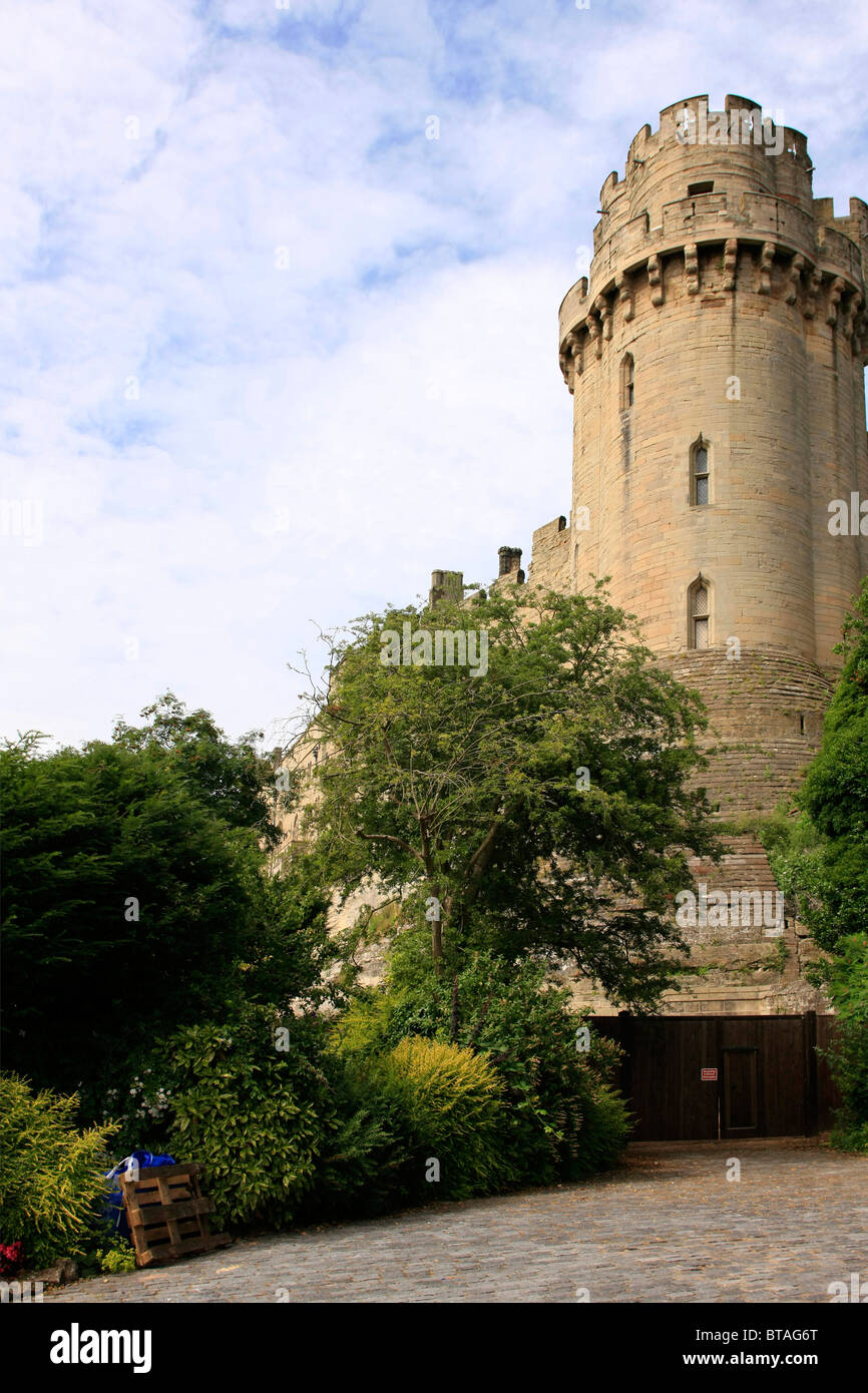 A medieval castle turret on the outside of Warwick Castle overshadowing ...