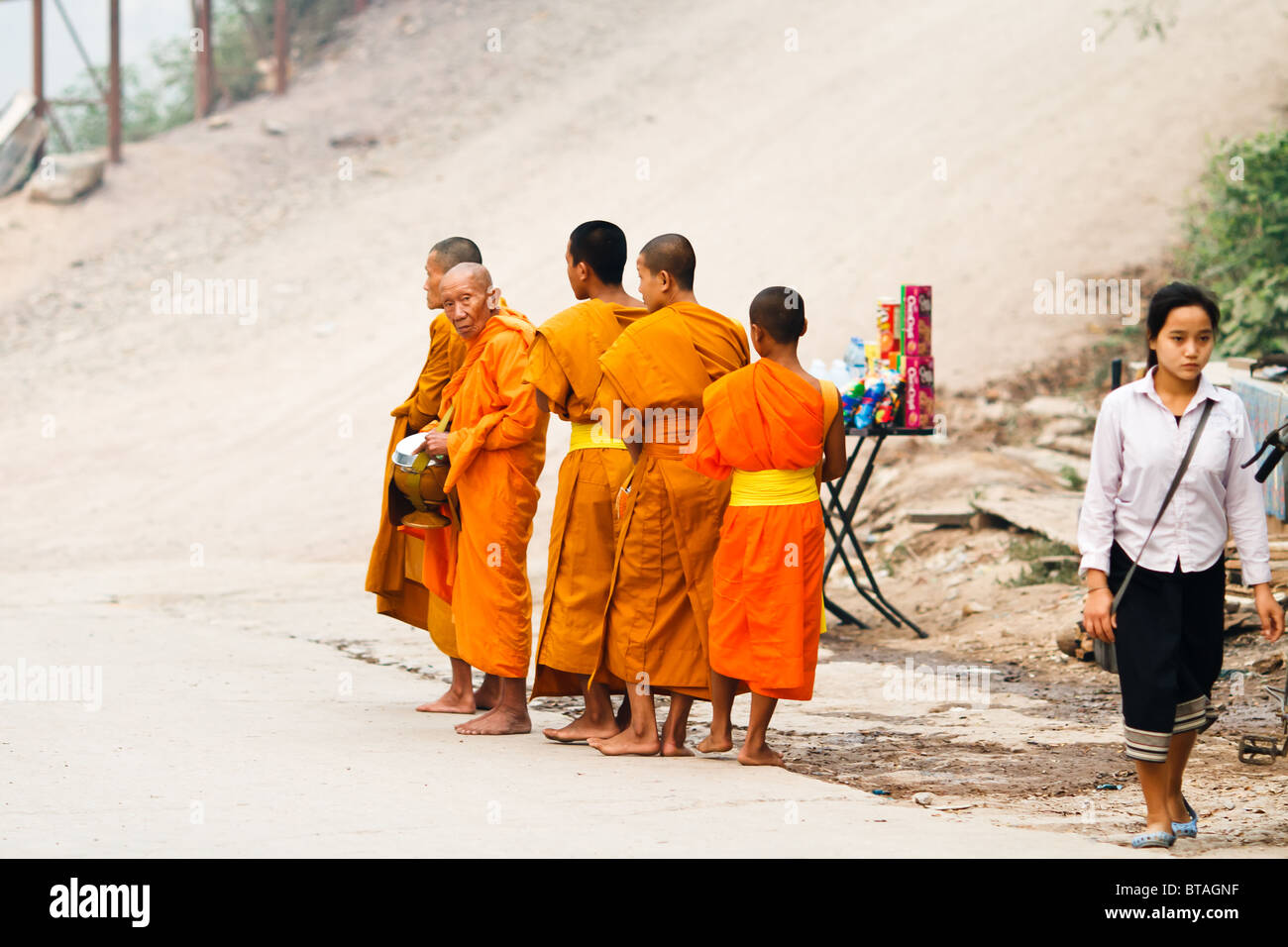 A curious elder monk takes a look at a passerby during his morning Alsm ...
