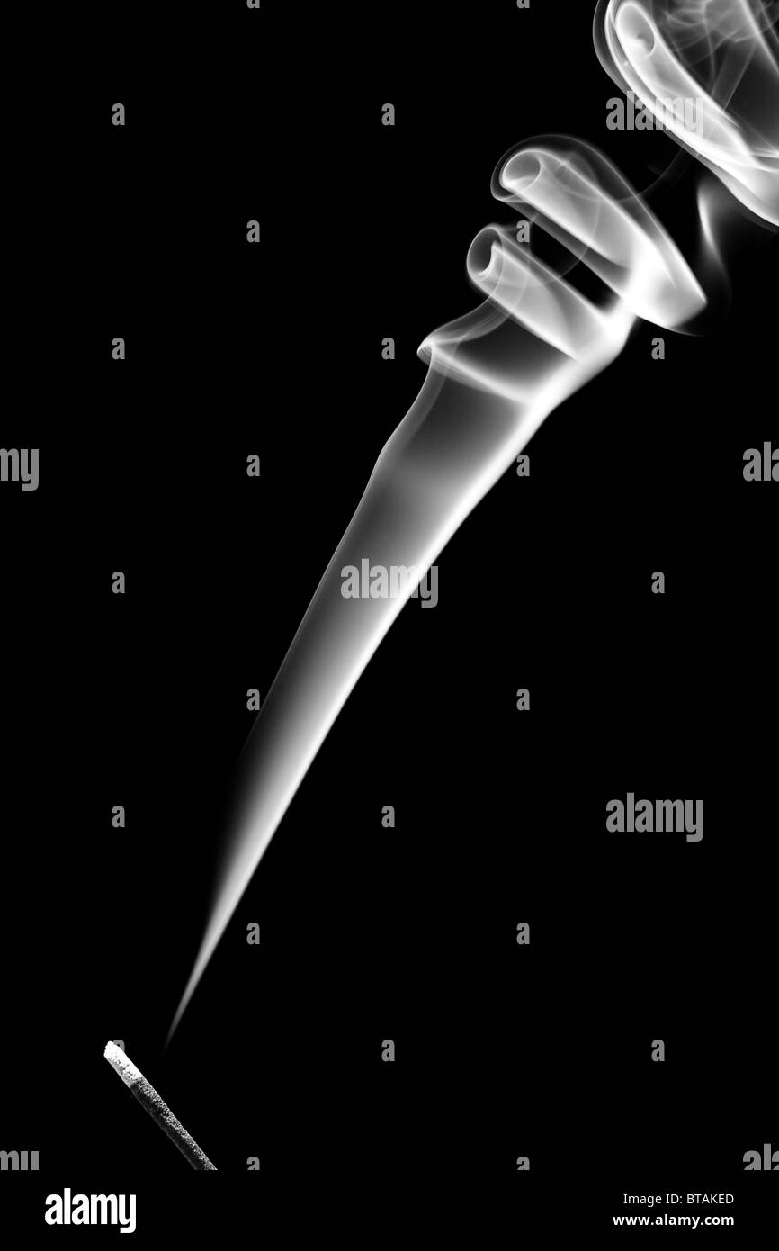 Stick with a white smoke. Isolated on black Stock Photo - Alamy
