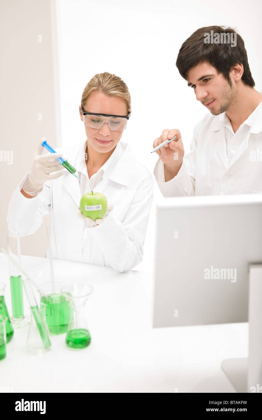 Genetic engineering - scientists in laboratory, GMO testing experiment ...