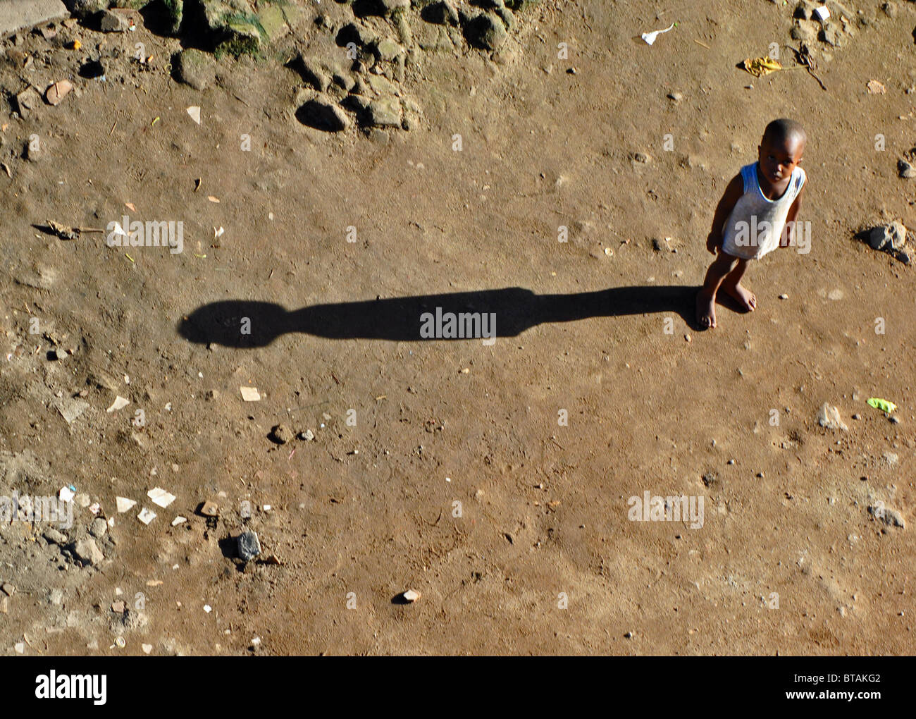 Small African child with long shadow. Abidjan, Ivory Coast, West Africa ...