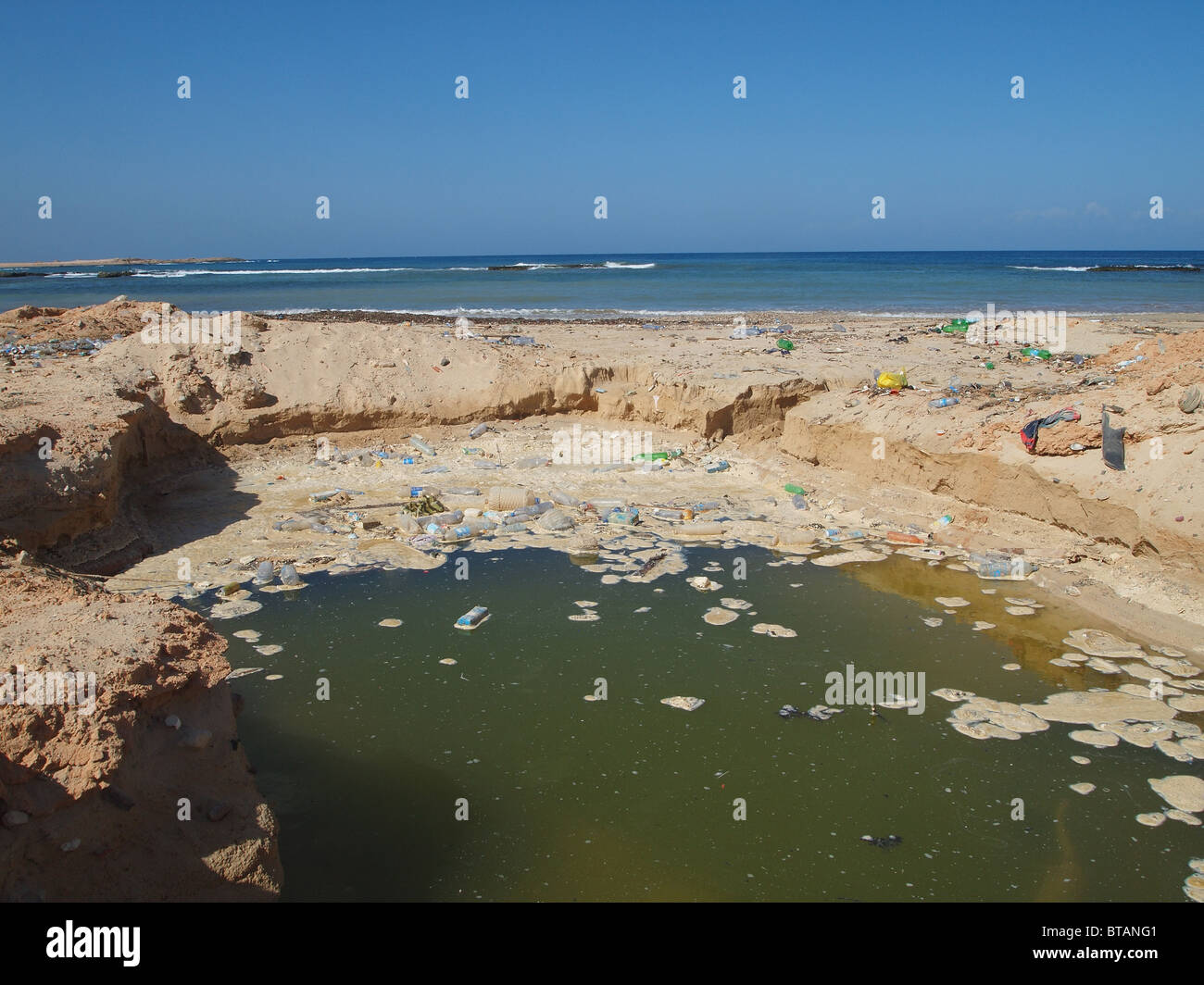 A sewage pipe empties its contents onto a Mediterranean beach in ...