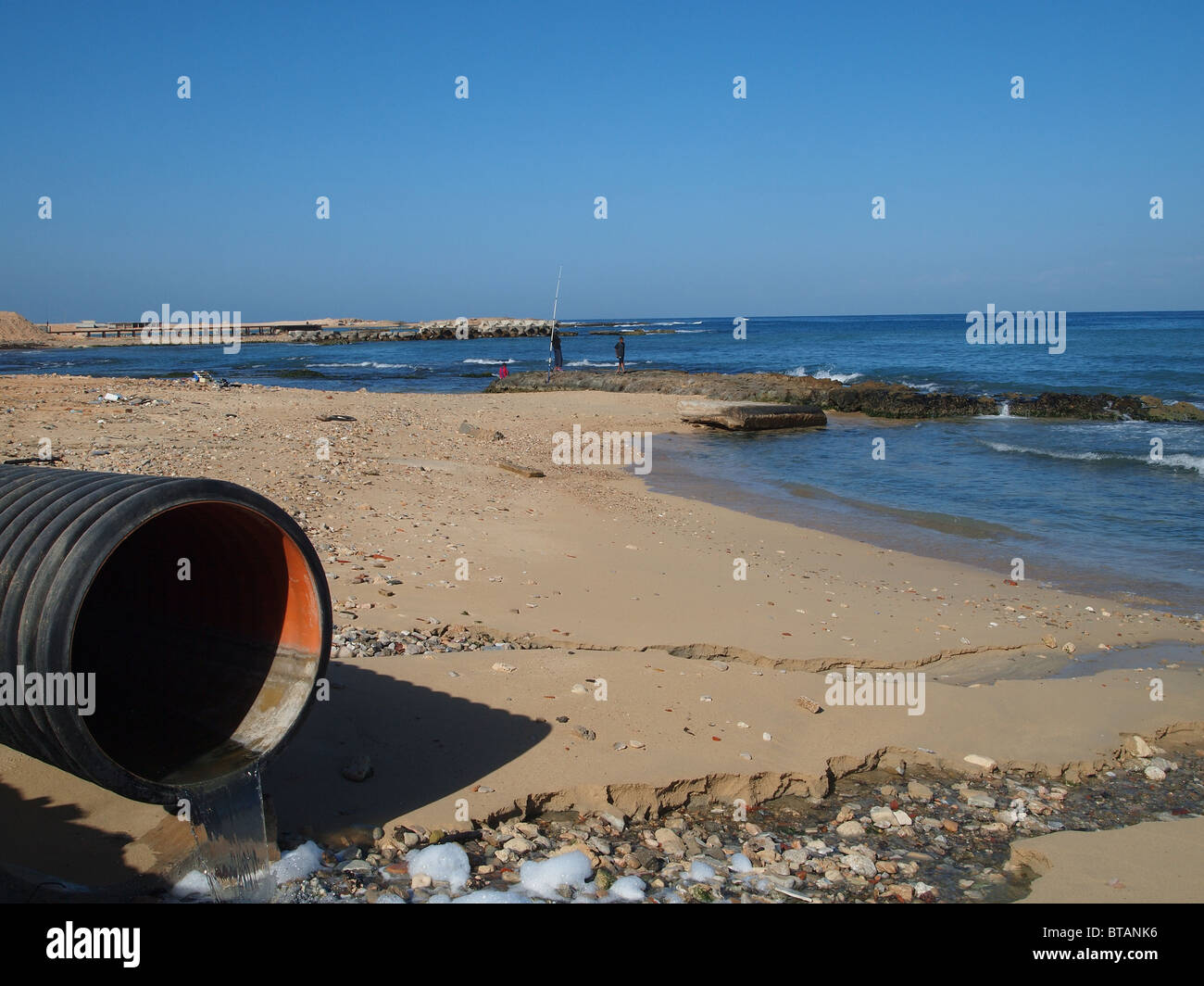 A sewage pipe empties its contents onto a Mediterranean beach in ...