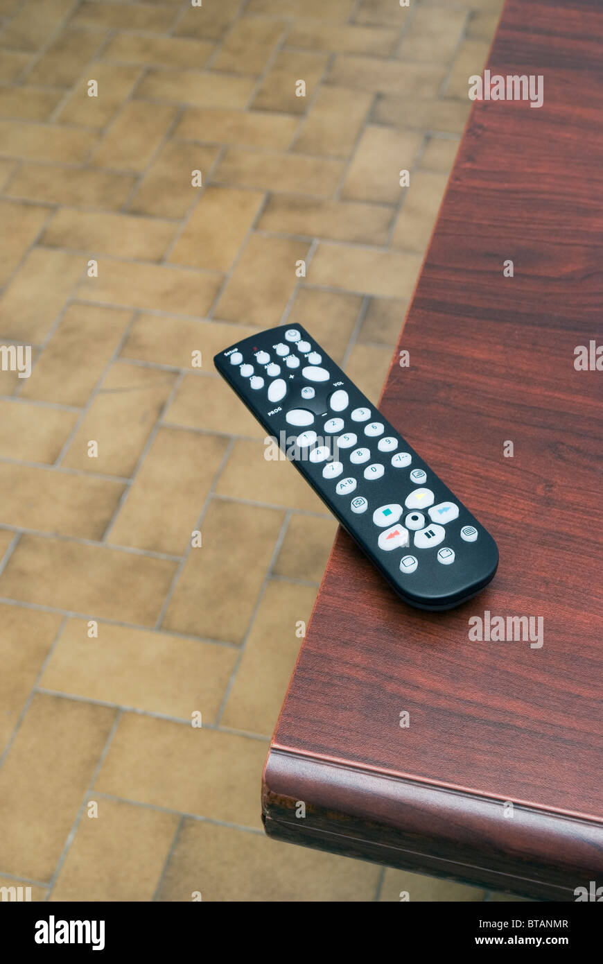 tv remote control on edge of table Stock Photo - Alamy