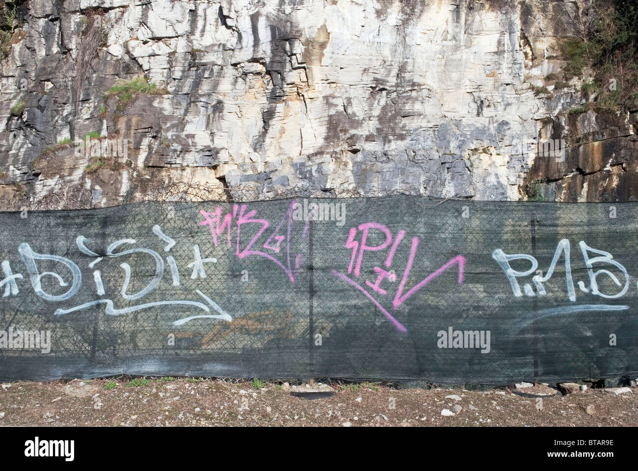 quarry behind fence with graffiti Stock Photo - Alamy
