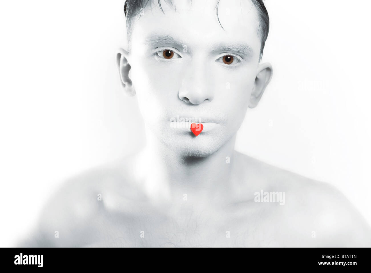 portrait of young brunette man with white skin and red heart on lips ...