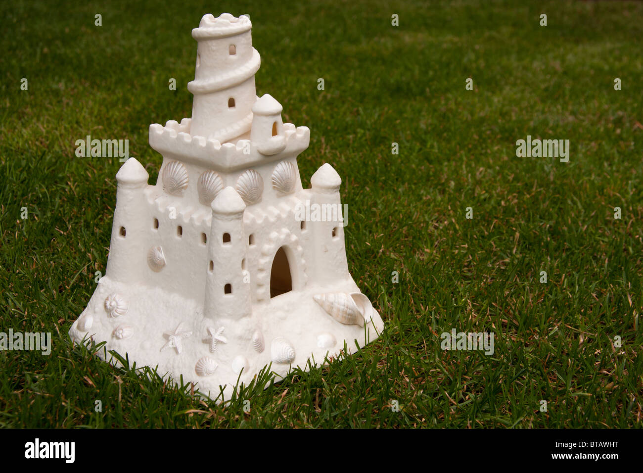 closeup image sand castle in the grass Stock Photo - Alamy