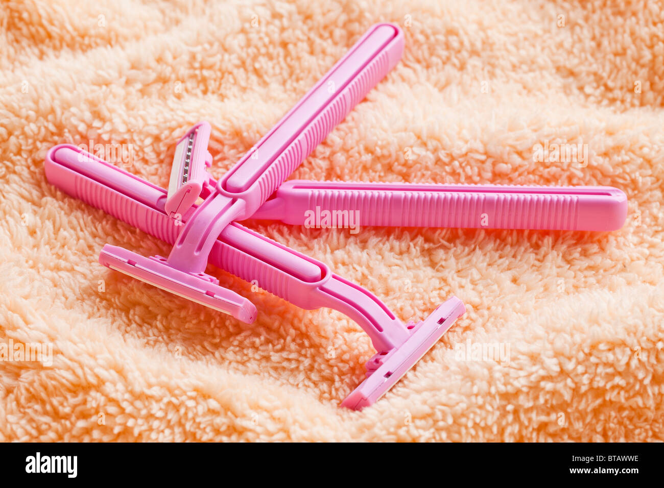 pink lady shaver on orange towel Stock Photo - Alamy
