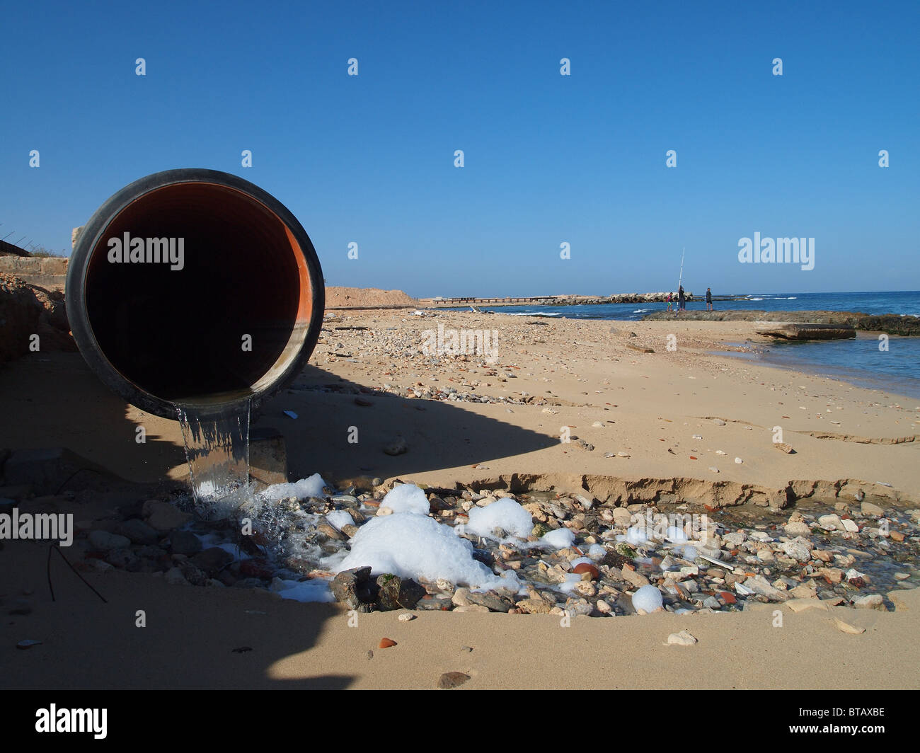 A sewage pipe empties its contents onto a Mediterranean beach in ...