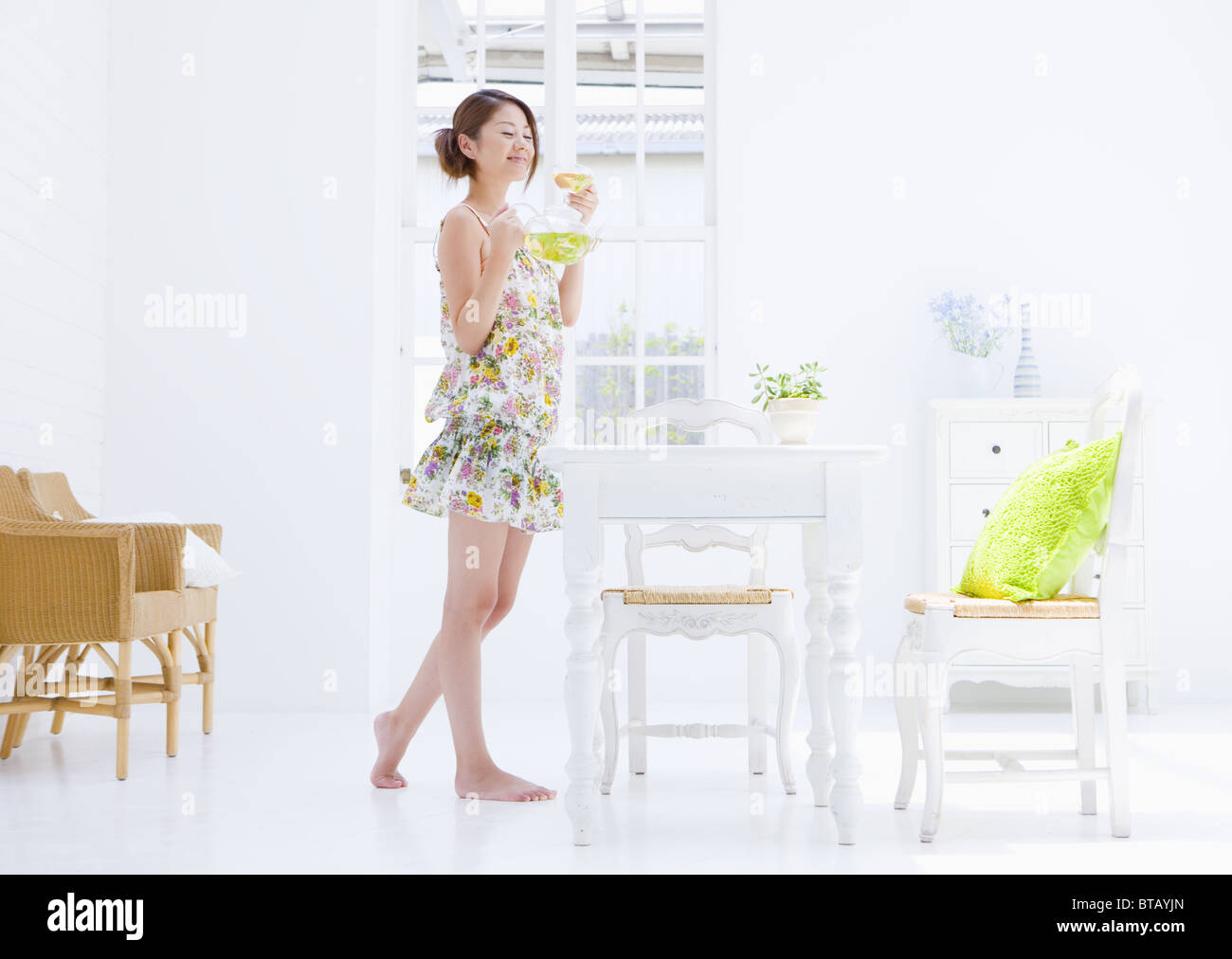 Young woman having tea Stock Photo - Alamy