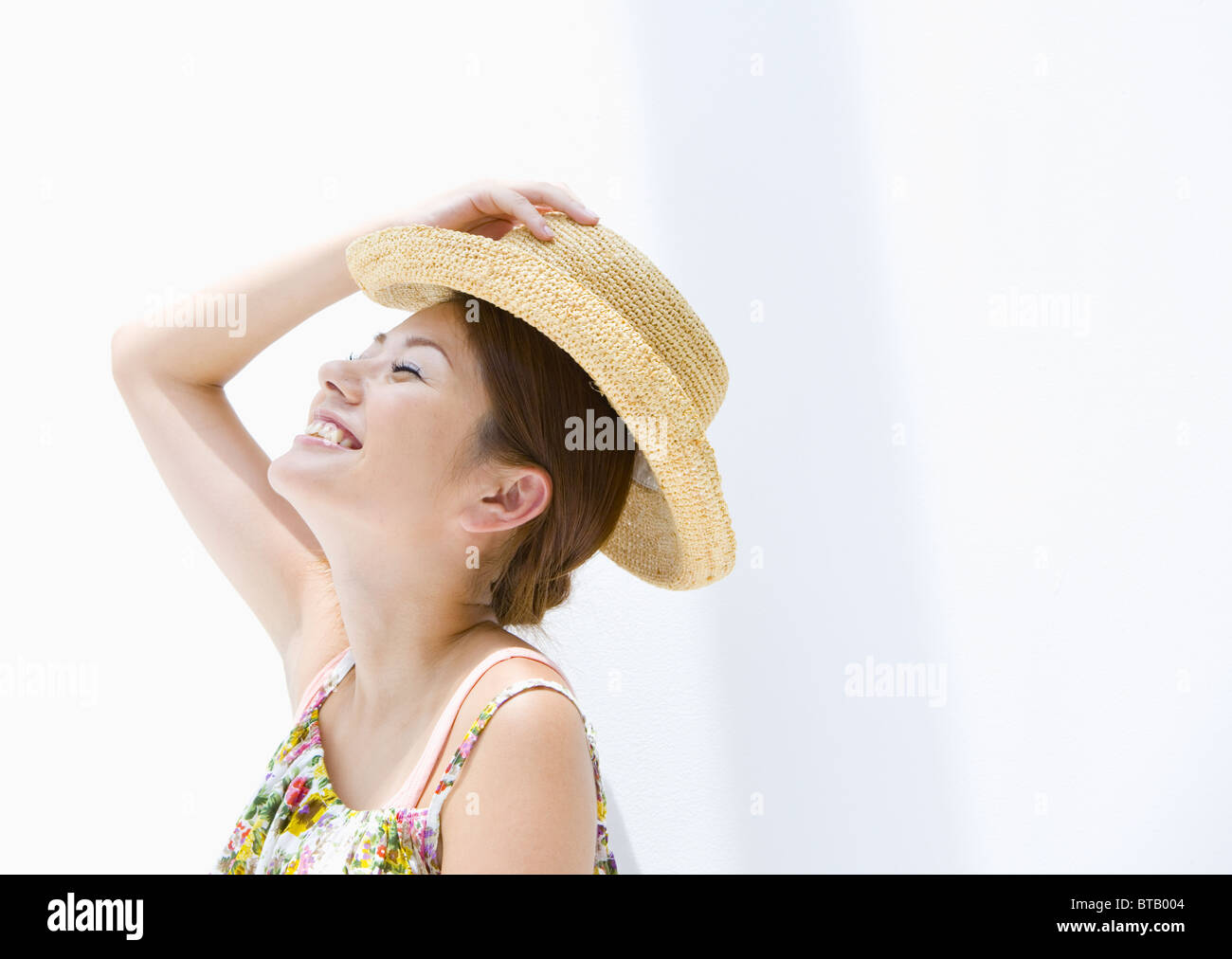 Young woman wearing straw hat Stock Photo - Alamy