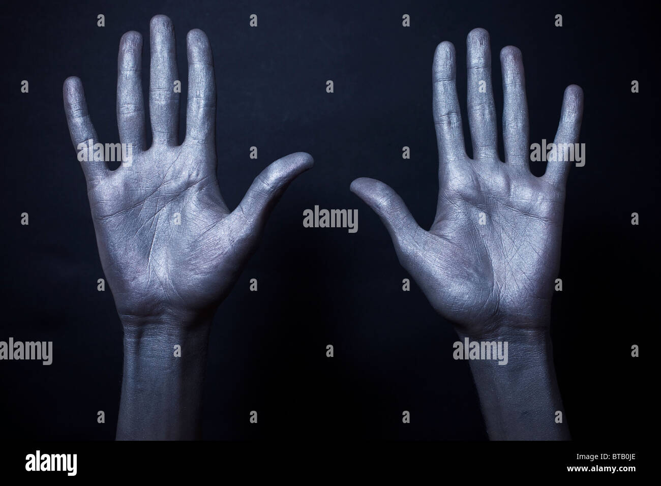 beautiful male hands in silver paint on black background closeup Stock ...