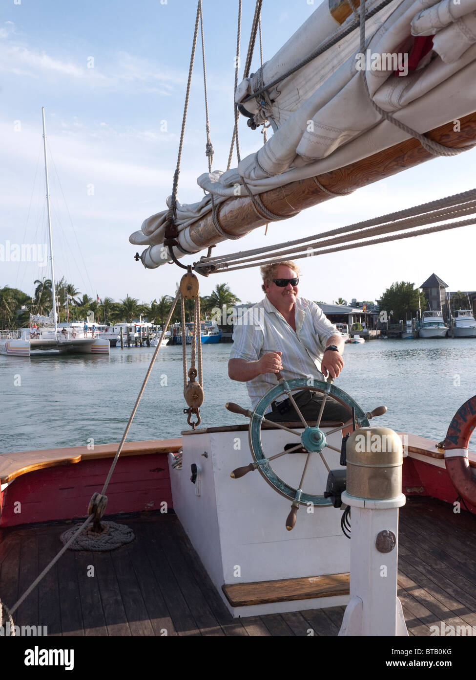 Helmsman steering the Sailing Ship the Schooner Appledore off Key West ...