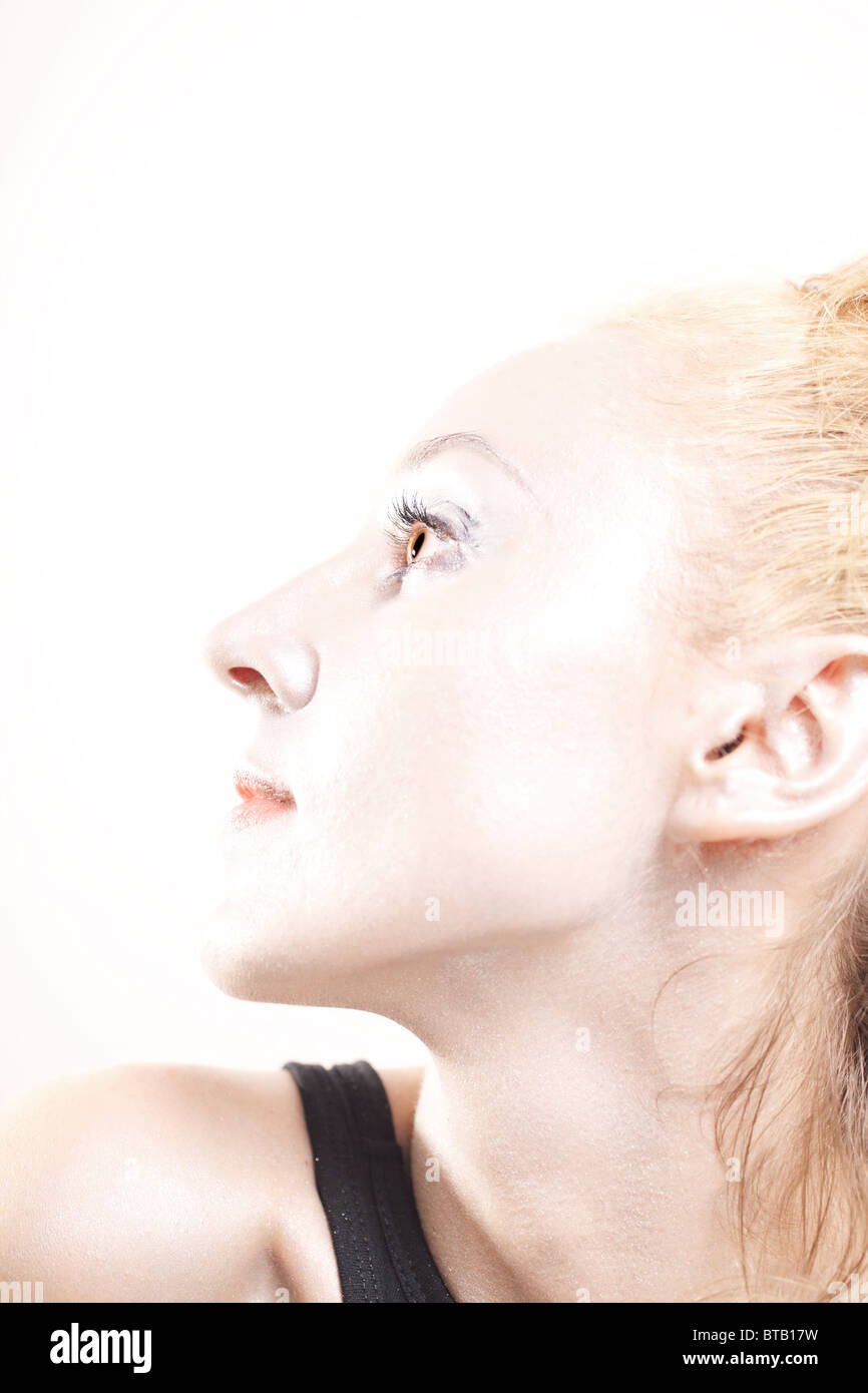 profile of beautiful young blond woman with shiny silver makeup on ...