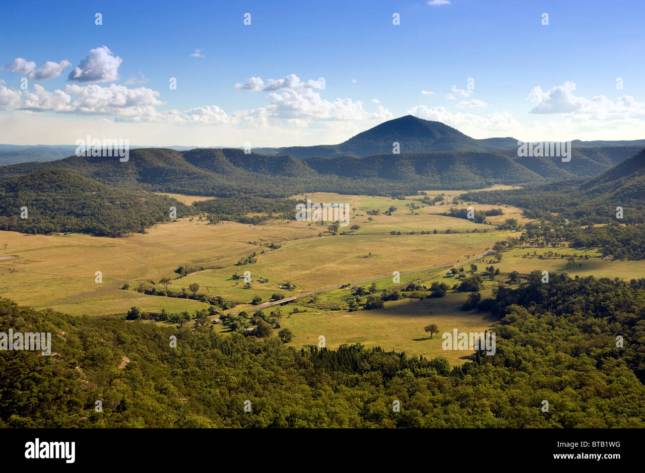Clearing in a remote country valley with a single road Stock Photo - Alamy