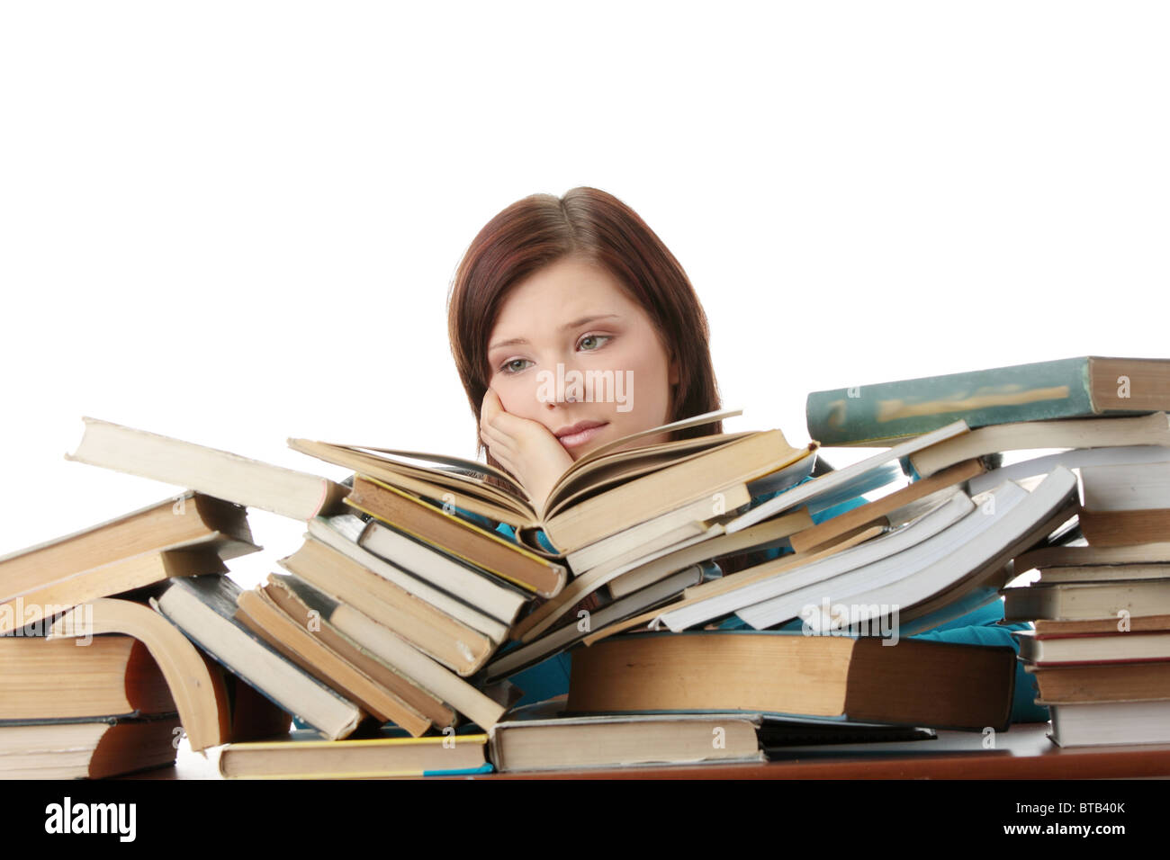 Young woman behind books, isolated on white background Stock Photo - Alamy