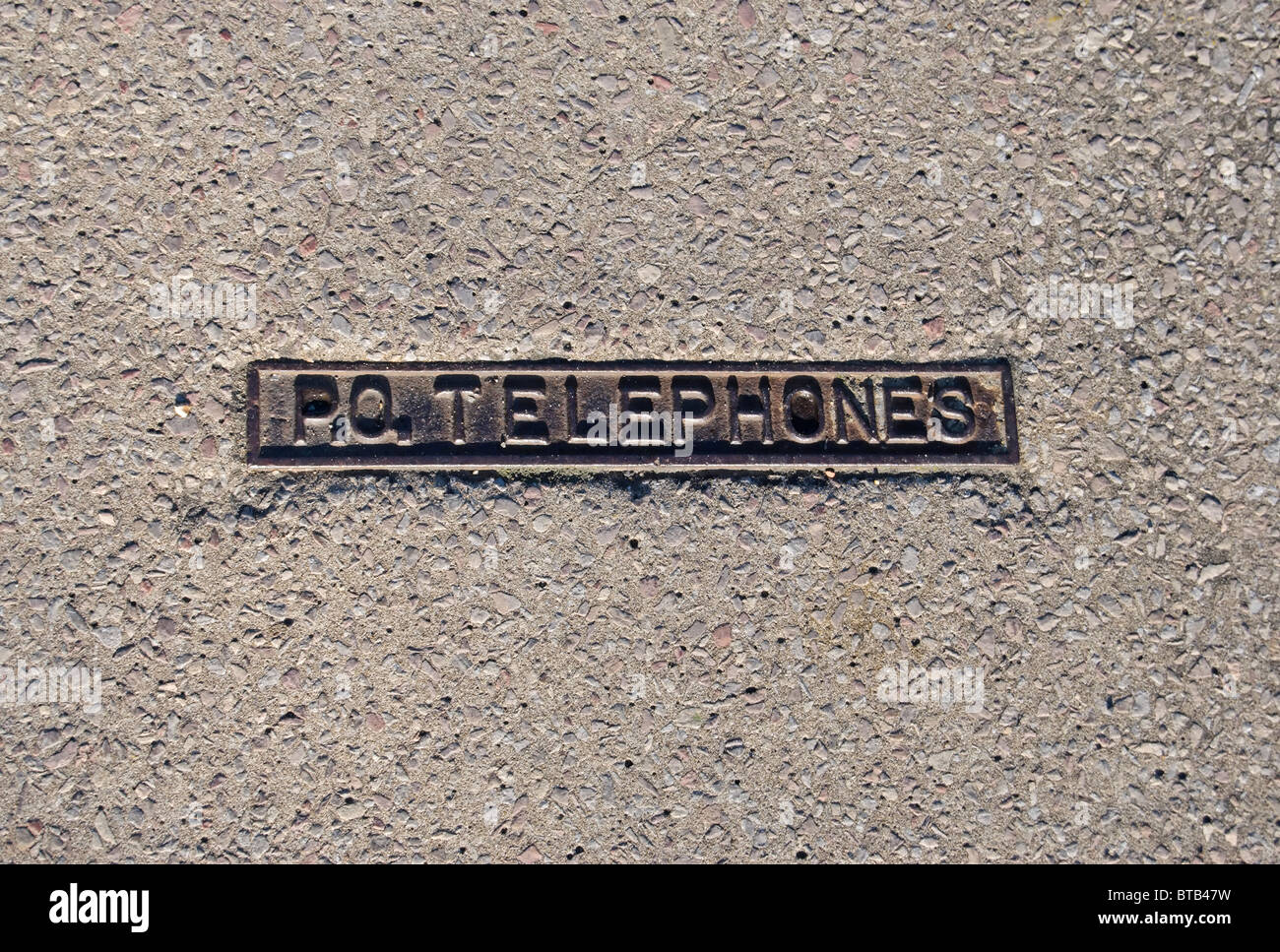 british manhole cover with name plate of p.o. telephones, referring to ...