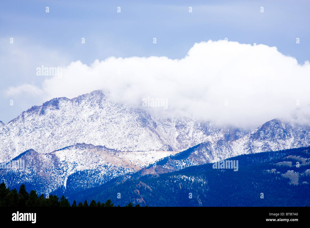 Storm clouds roll in from the west to envelope Pikes Peak in a blanket of mist and clouds Stock ...