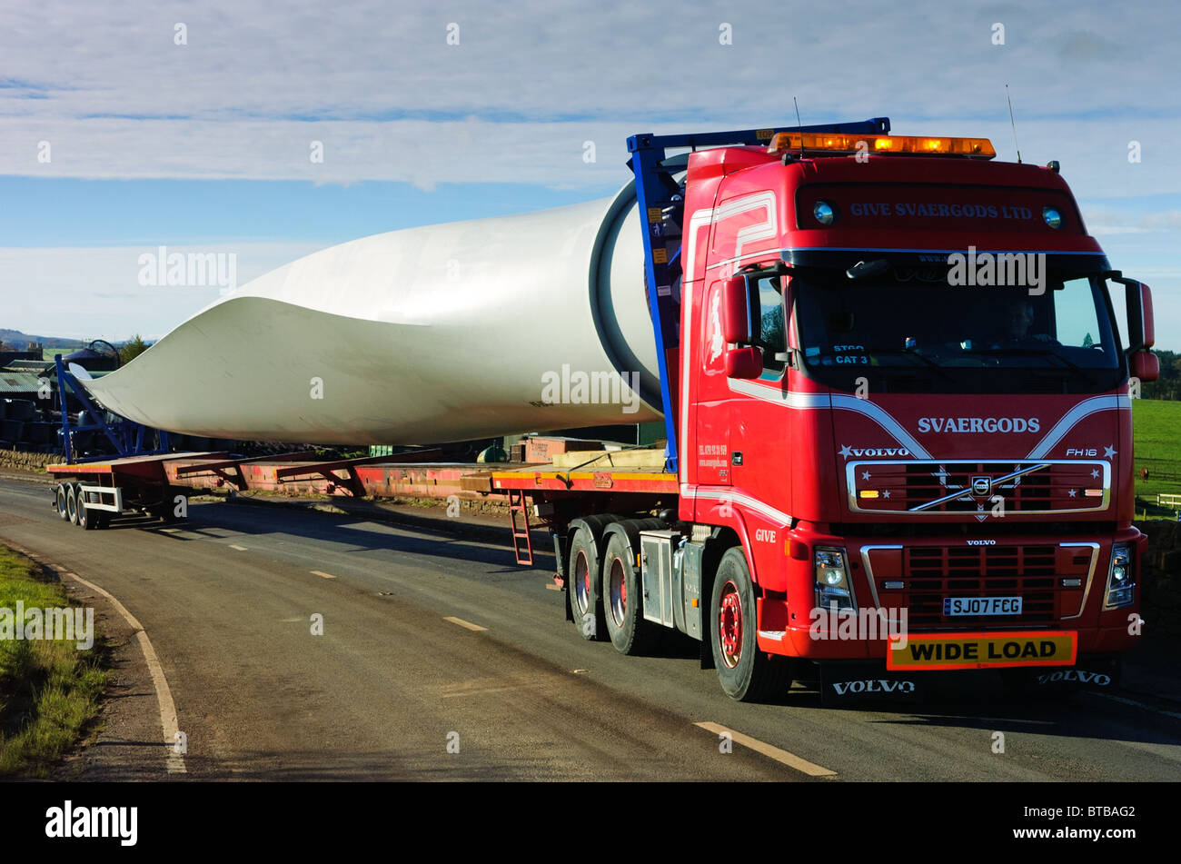 Giant blades for a wind turbine being transported by road in South ... Giant blades for a wind turbine being transported by road in South ...