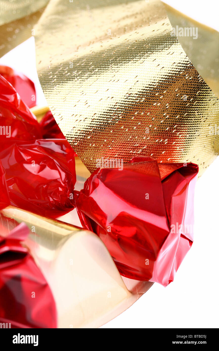 Red luxury sweets with golden ribbon isolated on white Stock Photo - Alamy