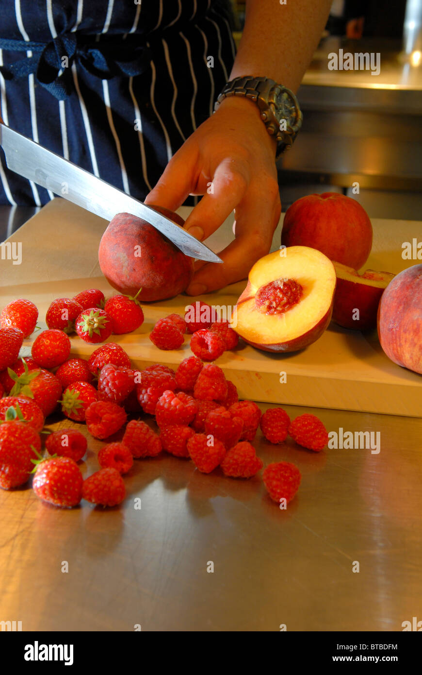 Celebrity chef Will Holland cutting fruit in the kitchen at Michelin ...