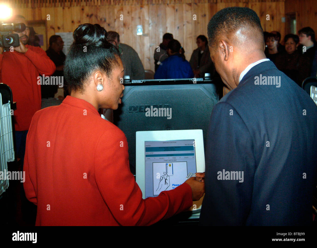 election worker shows a man how to use electronic voting, machine Stock ...