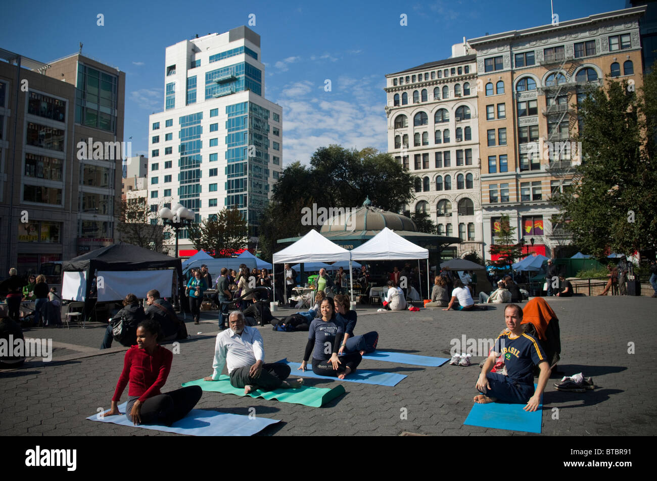 Yoga practitioners of all levels participate in a free yoga class given ...