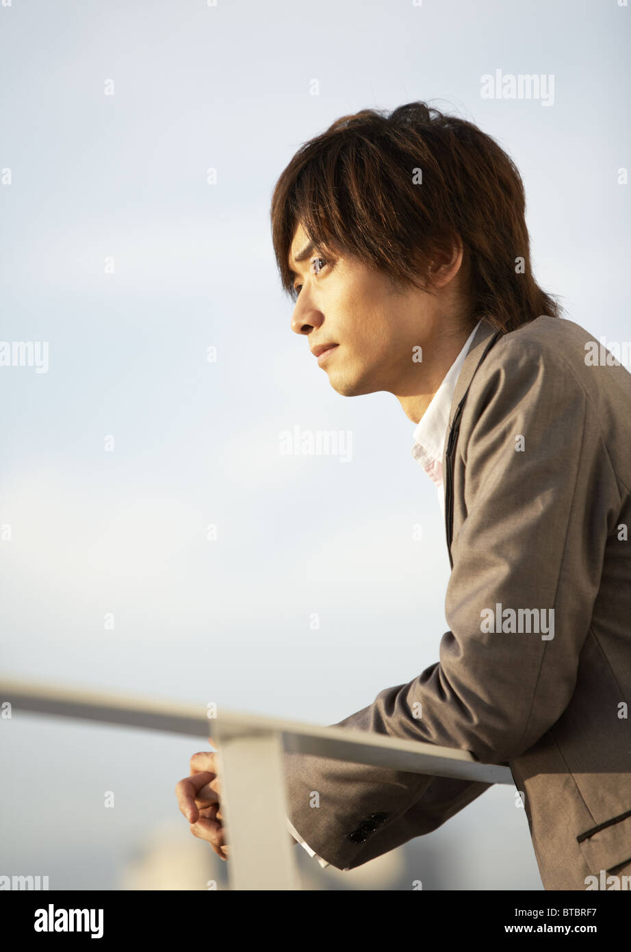 Young man looking at distance Stock Photo - Alamy