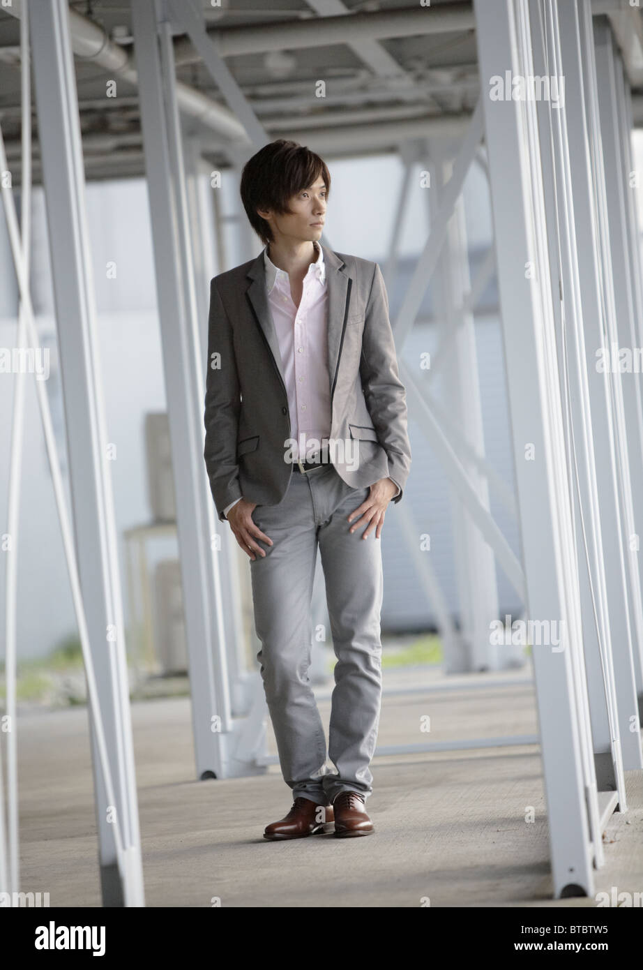 Young man standing Stock Photo - Alamy