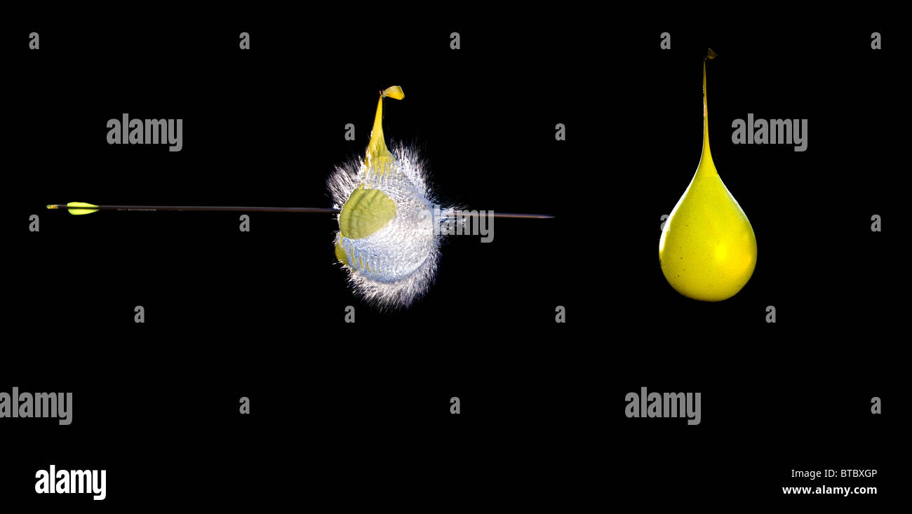 Balloon with water bursting hit by arrow Stock Photo - Alamy