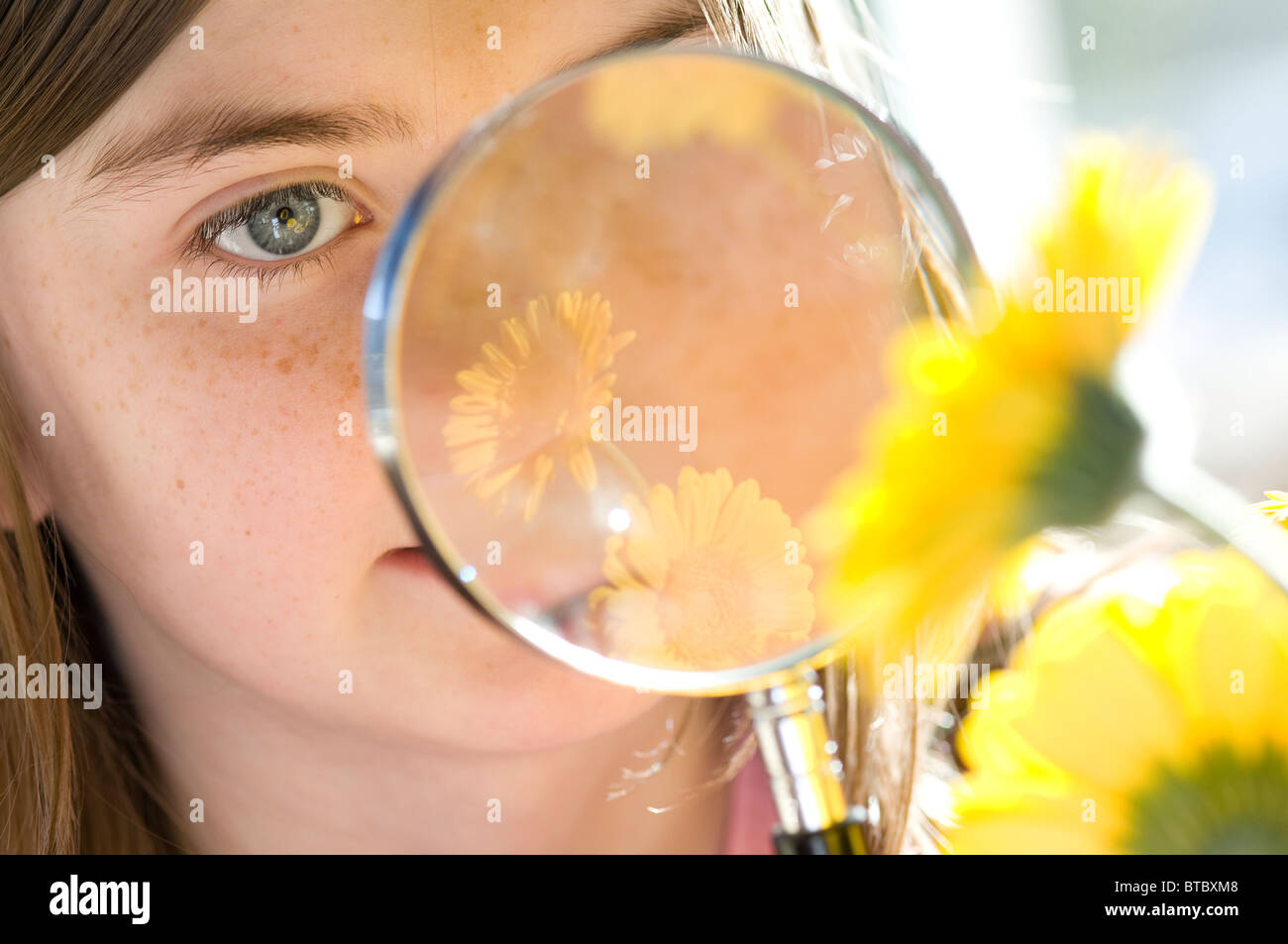 young female looking at flower through magnifying glass Stock Photo - Alamy