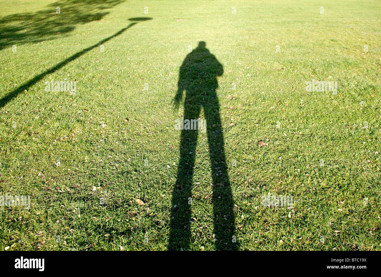 PHOTOGRAPHER SHADOW ON LAWN Stock Photo - Alamy