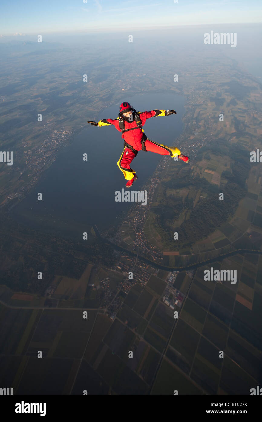 Girl is training the sit flight position in freefall with 120 MPH over ...